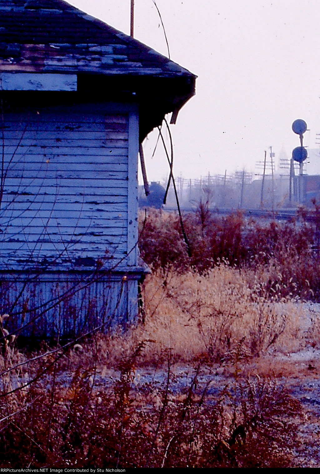 Tail end of NS freight disappears behind old signal shanty at Marion, OH.