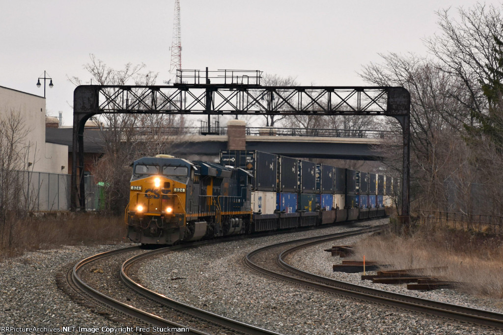 CSX 824 leads the train under the old Pennsy signal bridge,