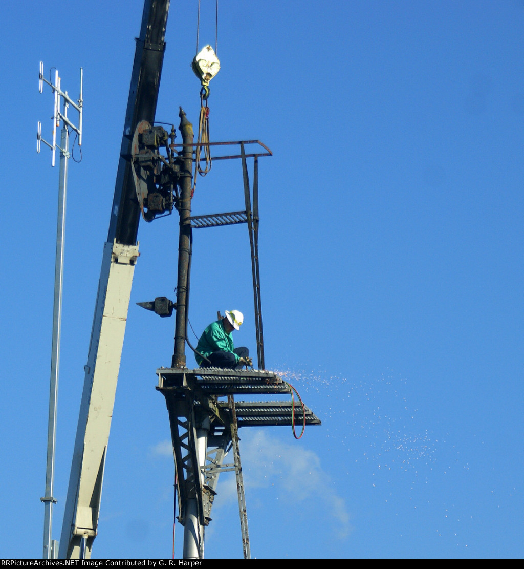 More sparks fly from the cutting torch as the ladder is cut