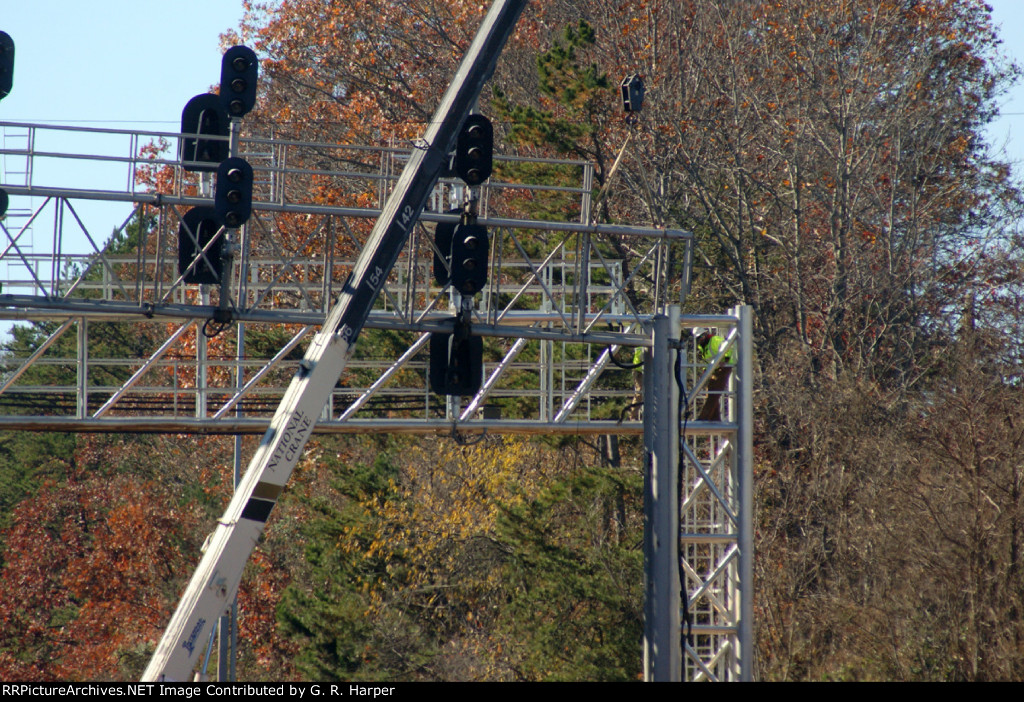 Signal man observes as signal bridge is eased up out of its supports