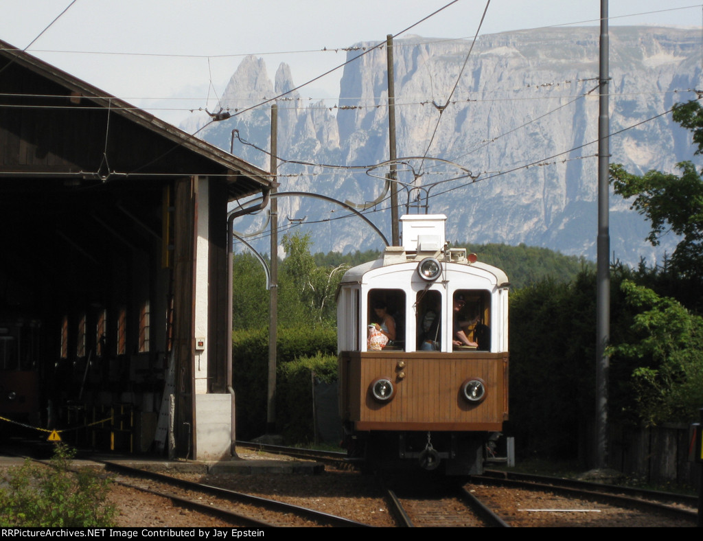 The trademark cliffs of the region dwarf a tiny train