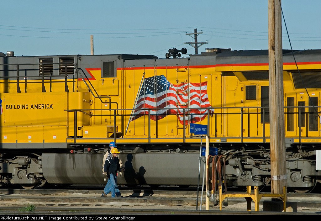 UP shops workers pass in front of a GEVO at the Centennial Yard Shops