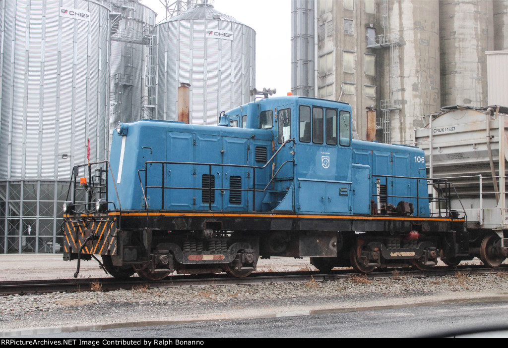 Center cab switcher behind a grain mill in town
