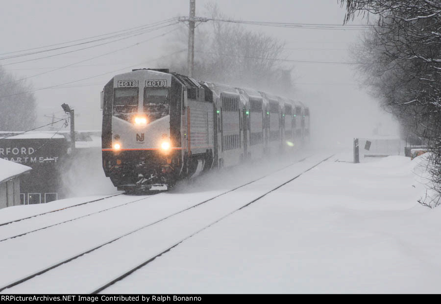 One of NJT's newer locomotives, a PL42AC leads bilevels westbound into ...
