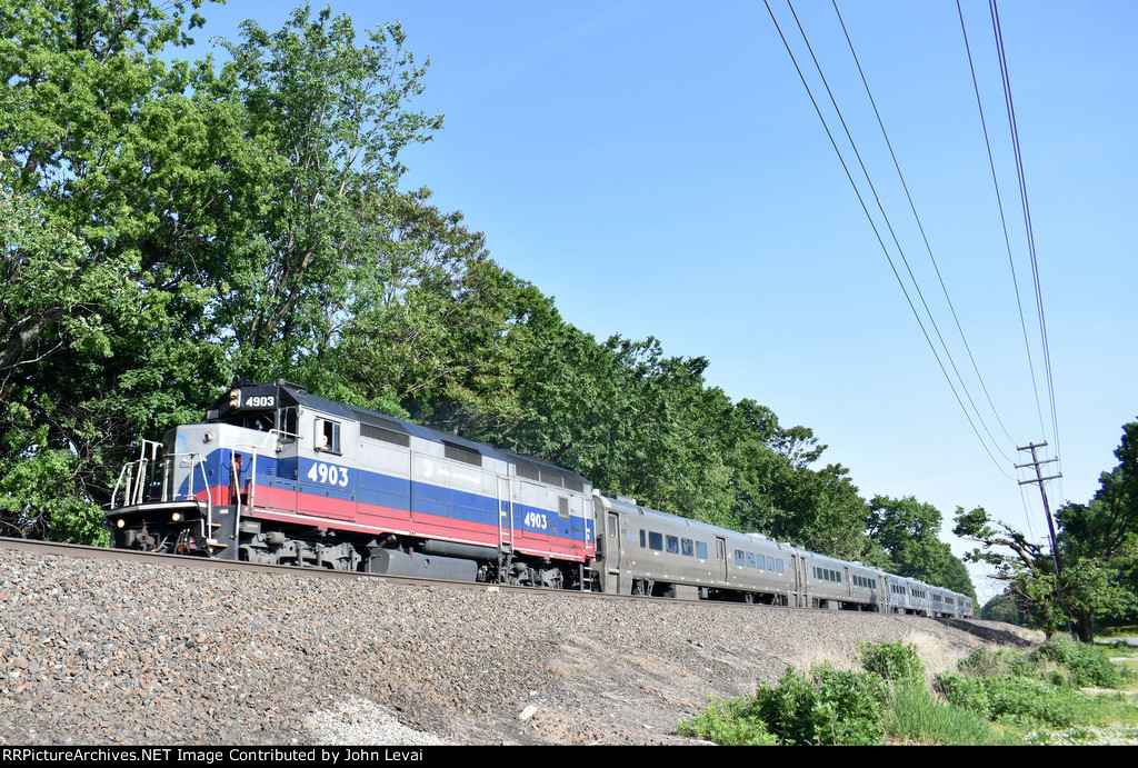 Westbound MNR WOH Train # 53 running along E. 55th St in Fair Lawn with ...
