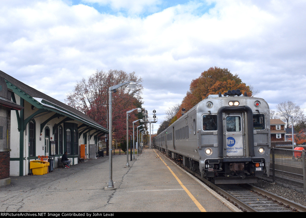 NJT Train # 76 races past the depot with a MNR Comet V Cab Car on the point