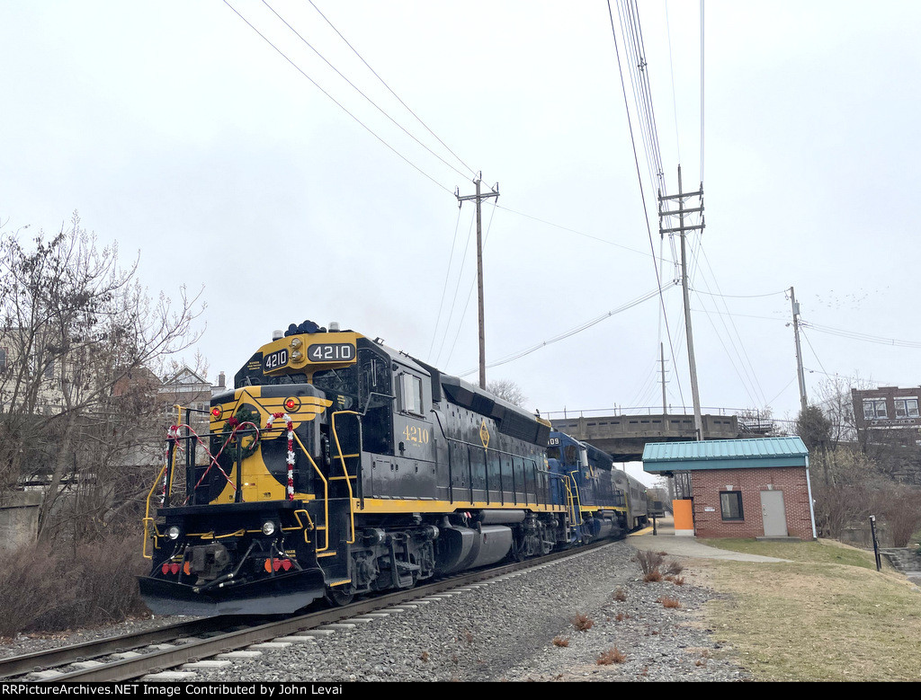 GP40PH-2 units # 4210 and 4109 shove the train as it passes the bus ...