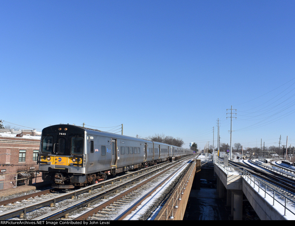 LIRR M7 consist, being led by Car # 7645, approaches the station. On ...