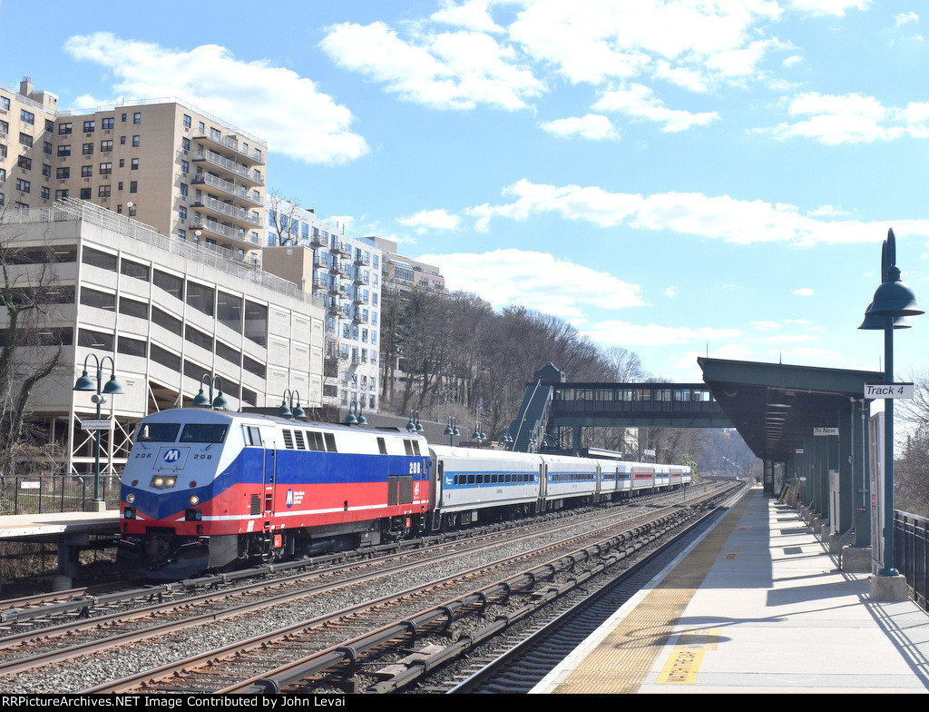 P32AC-DM # 208 in the Beachball colors leads northbound MNR Train # 837 ...