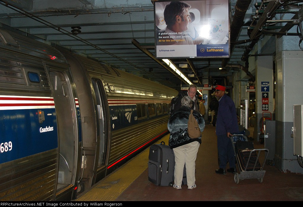 An Amtrak (AMTK) "Red Cap" assists "Empire Service" Passengers on the ...