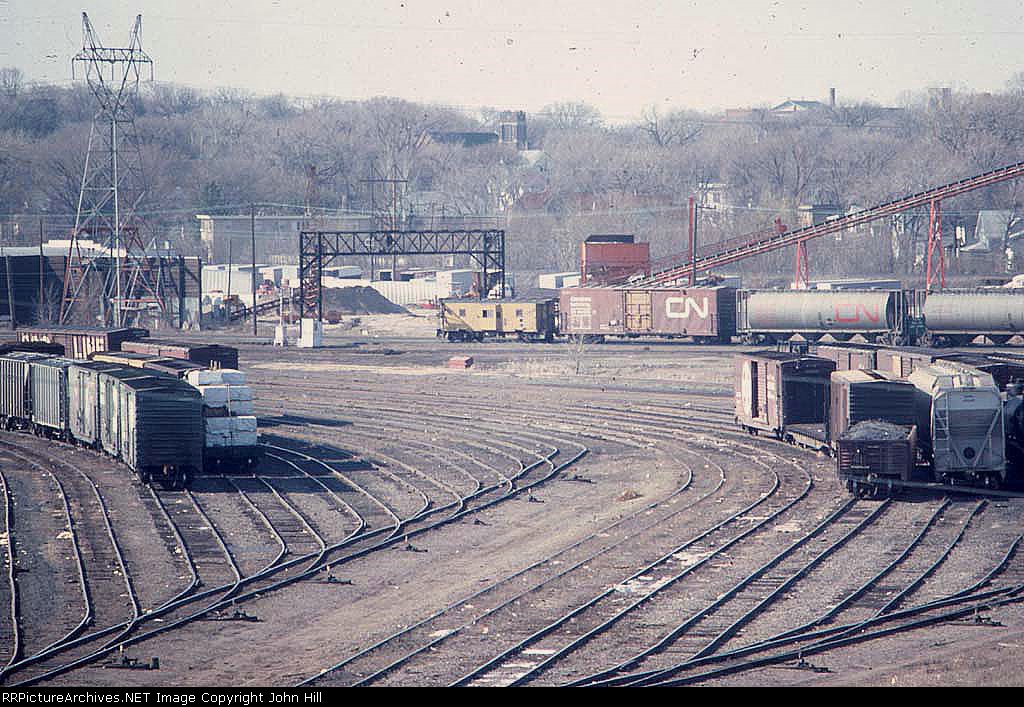 1042-31 Eastbound CNW freight seen on ex-GN main in background while ...