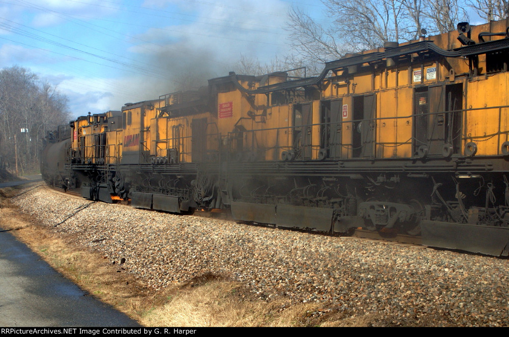 591 - Fire and smoke eminate from under the Loram rail grinder