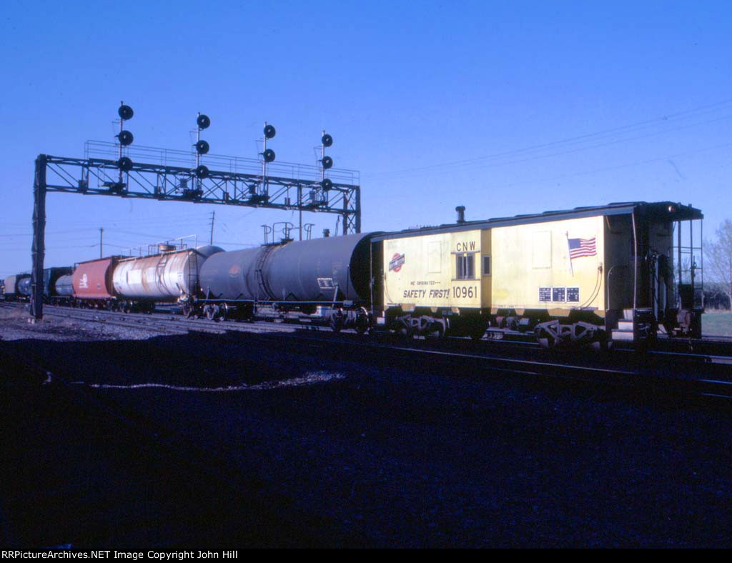 1332-29a C&NW freight rolls through BN CTC University