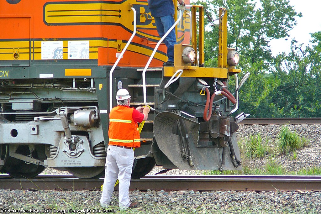 inspecting the locomotive after collision with car