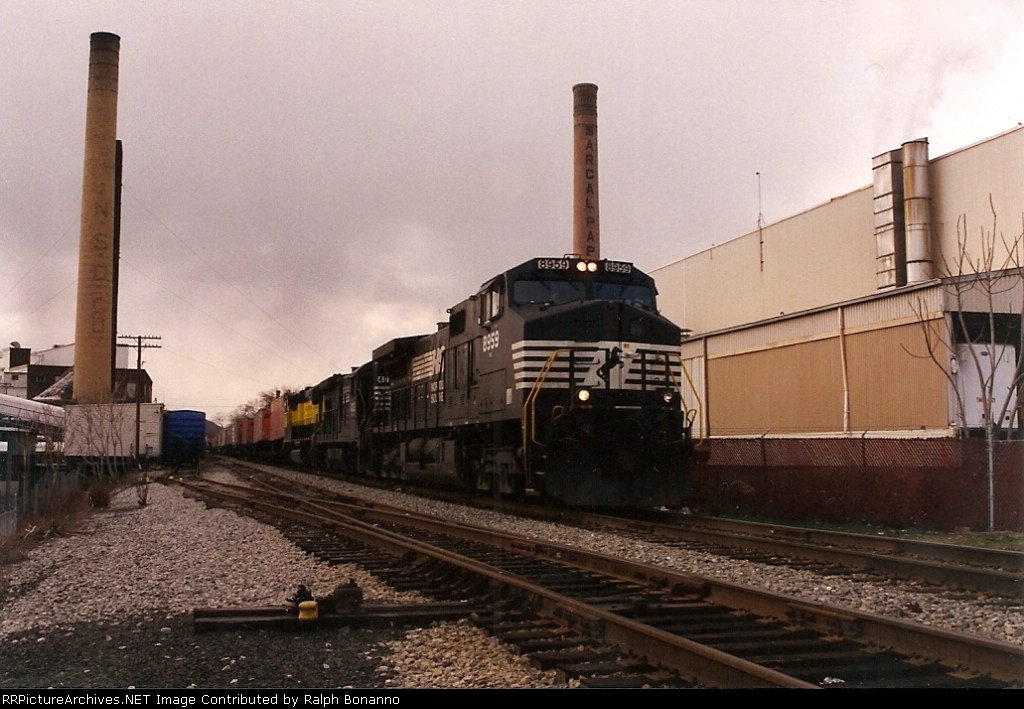 Train 258 rolls east past the Marcal paper factory complex at River Road