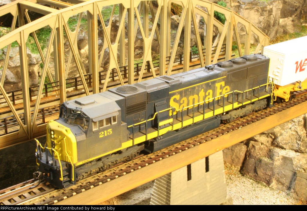 ATSF 215 leads a intermodal train across a dried up river