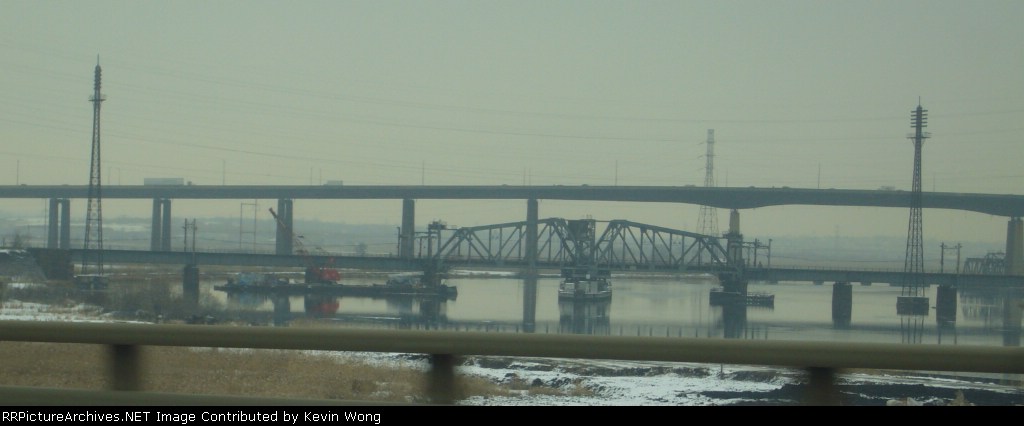 A barge and crane work on the Portal Bridge as the obsolete span ages ...