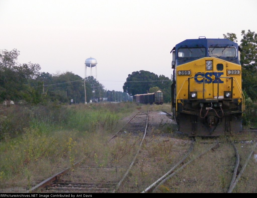 CSX 399 and a string of loaded wood chip cars