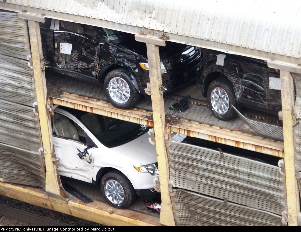 Close up of damaged cars on autorack at derailment