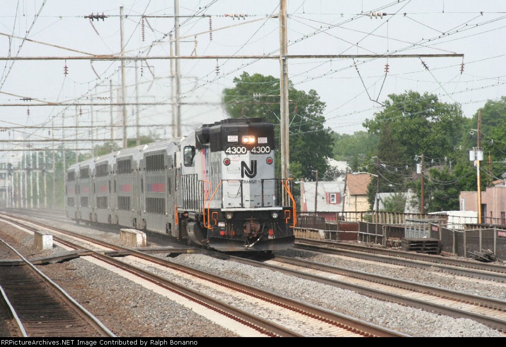An NJT GP40-2 hustles 5 Bilevel coaches south/west in an equipment move