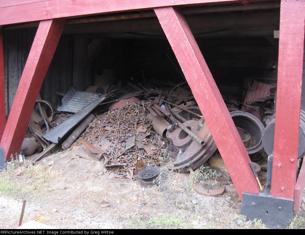 Some scrap steel stored under one of the buildings