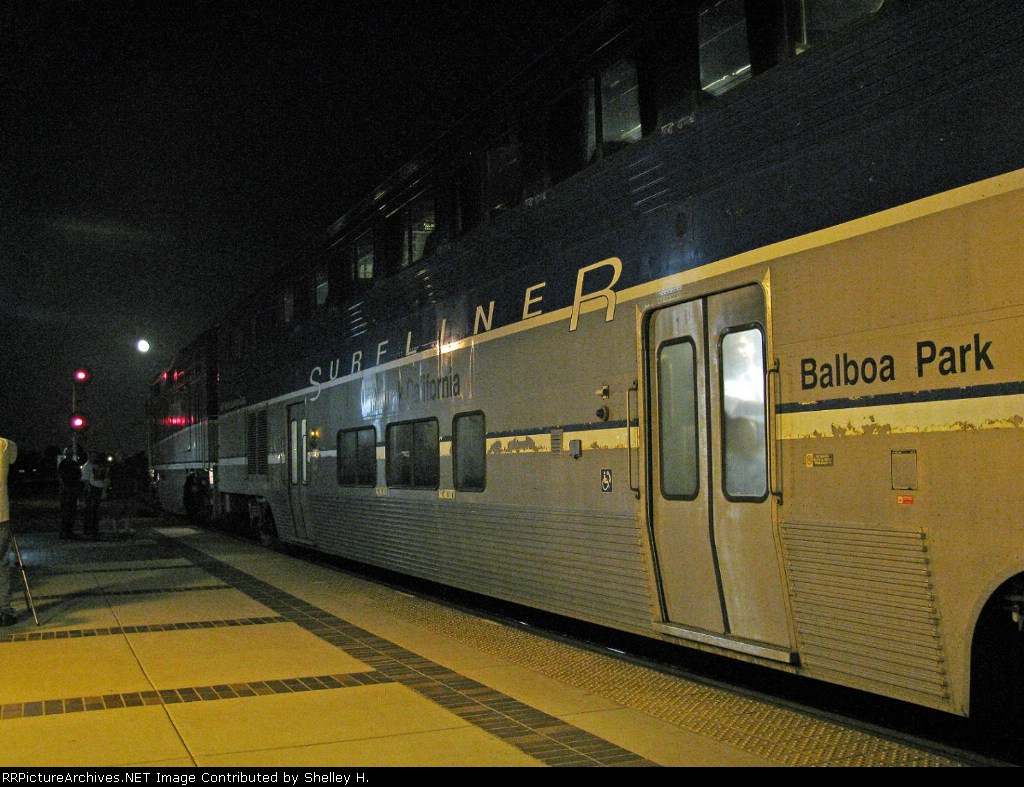 A Full moon in the sky as a double ended Amtrak train sits in the station