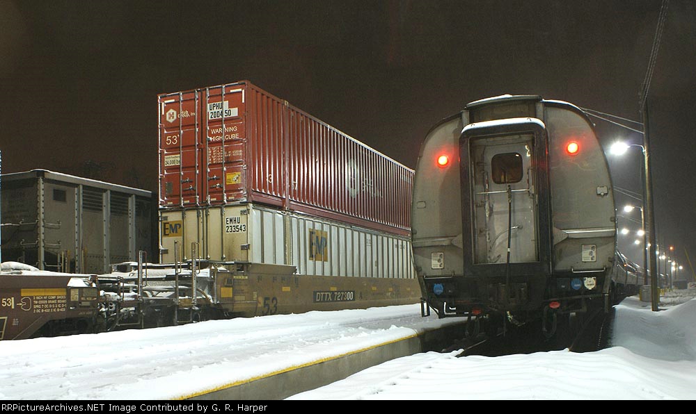 Three motionless trains at Kemper Street station. NS 88M, NS 203, and ...