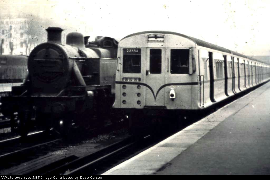 District Line R Stock headed by an R49 car at Kensington Olympia