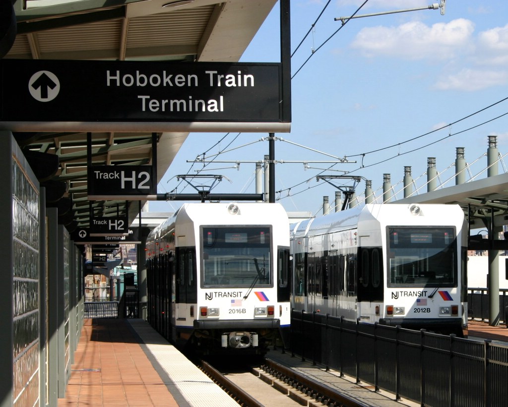 Two HBLR trainsets wait at Hoboken.