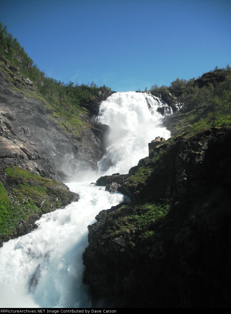 All 365 feet of the Kjos Waterfall beside the railway
