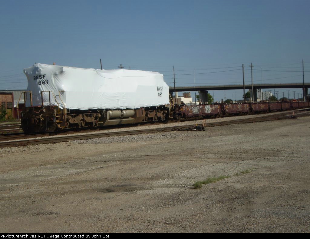 Shrink wrapped locomotive at 8th Street