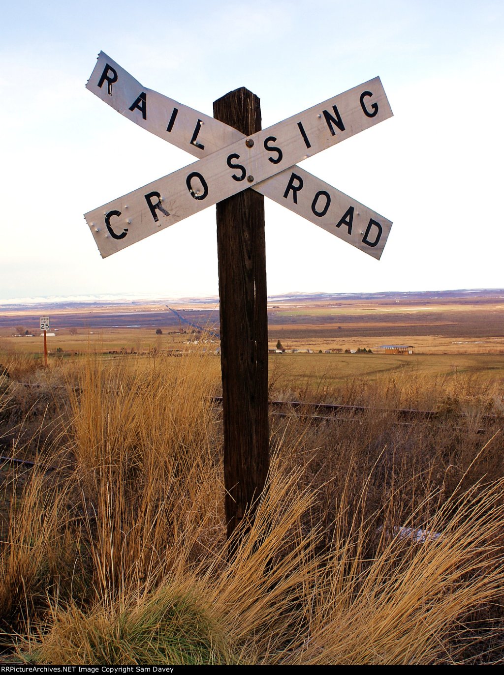 A ventage style crossbuck guards a quiet crossing.