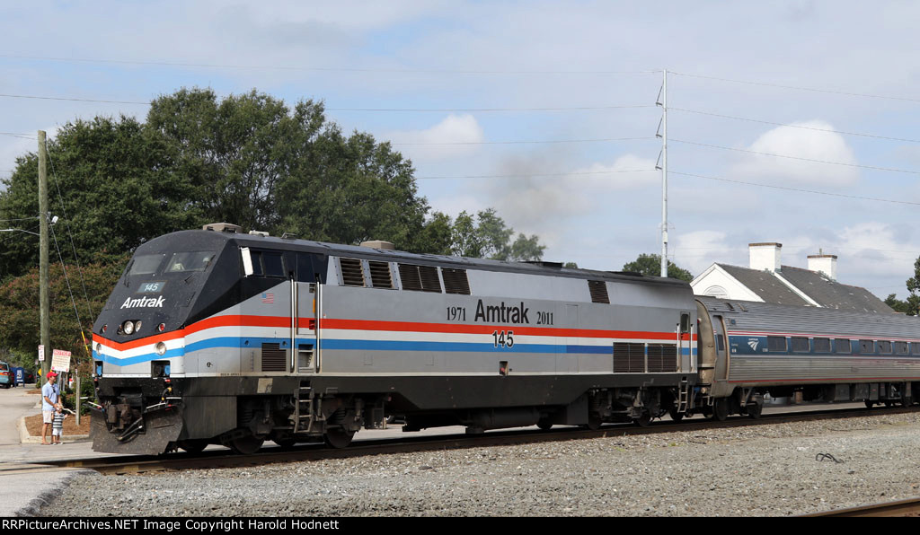 AMTK 145 leads trahn 80 away from the station