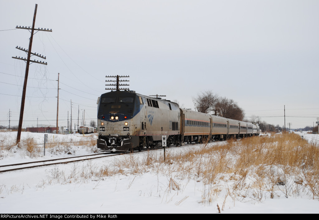 AMTX 128 with train 301 passes by at W R tower