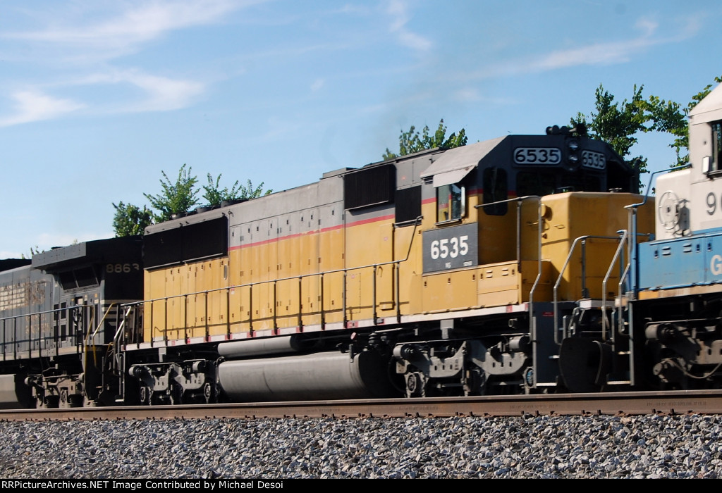 NS Patch job SD-60#6535 is mid consist on a westbound next to Railroad Ave