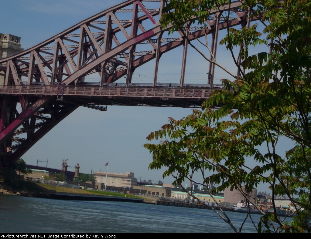 Regional #93 heads south over the Hell Gate Bridge
