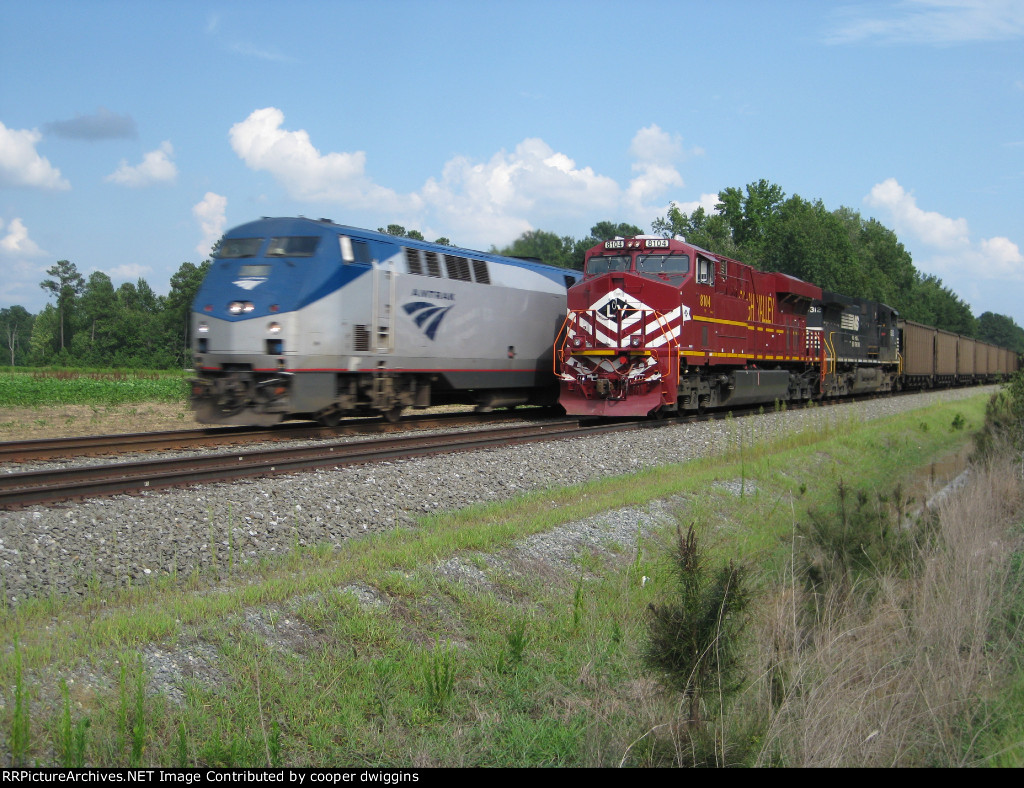 Amtrak 79 zips by 8104 tied down on 847