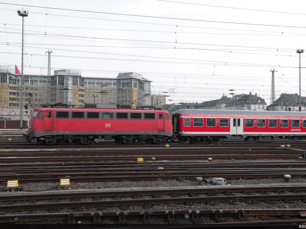 Class 110 arriving with a commuter train.