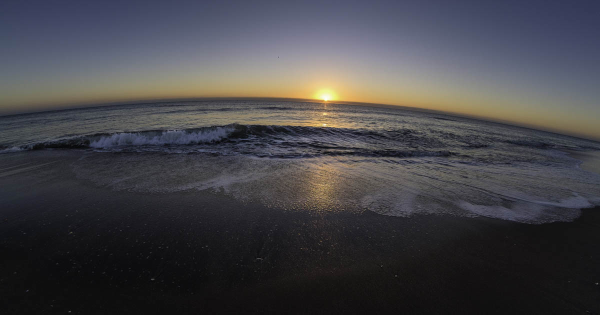 Fish-eye lens of beach against sky during sunset - StockFreedom ...