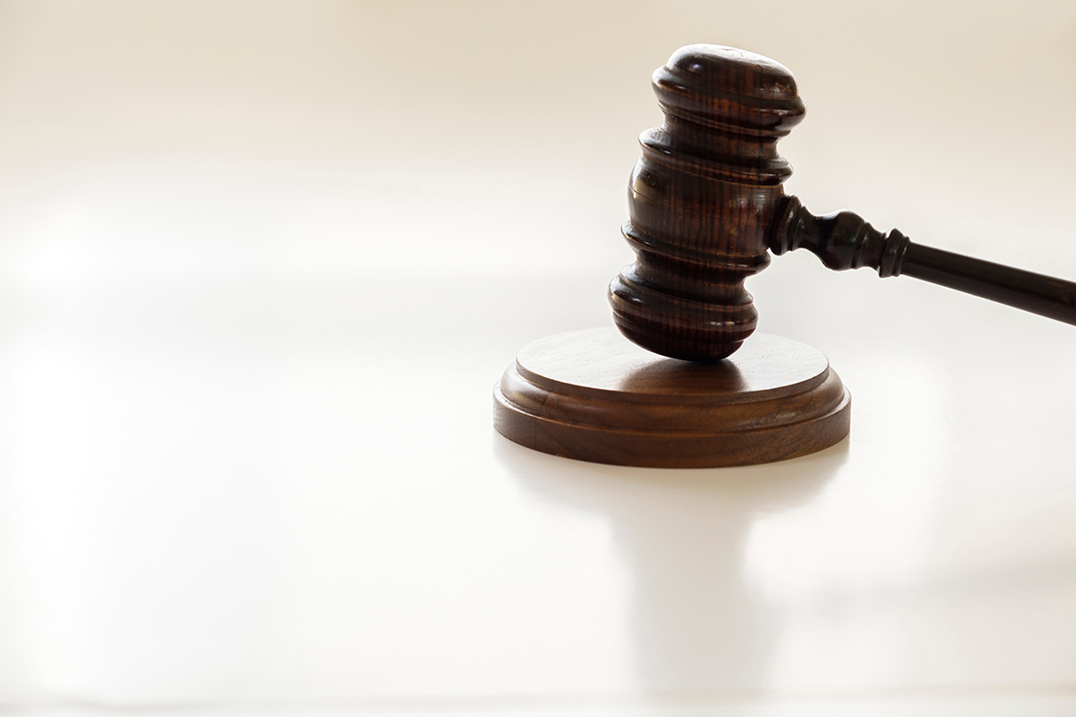 Striking gavel against a white background - StockFreedom - Premium ...