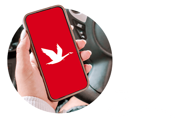 Customer holding phone with the Wawa App on the screen