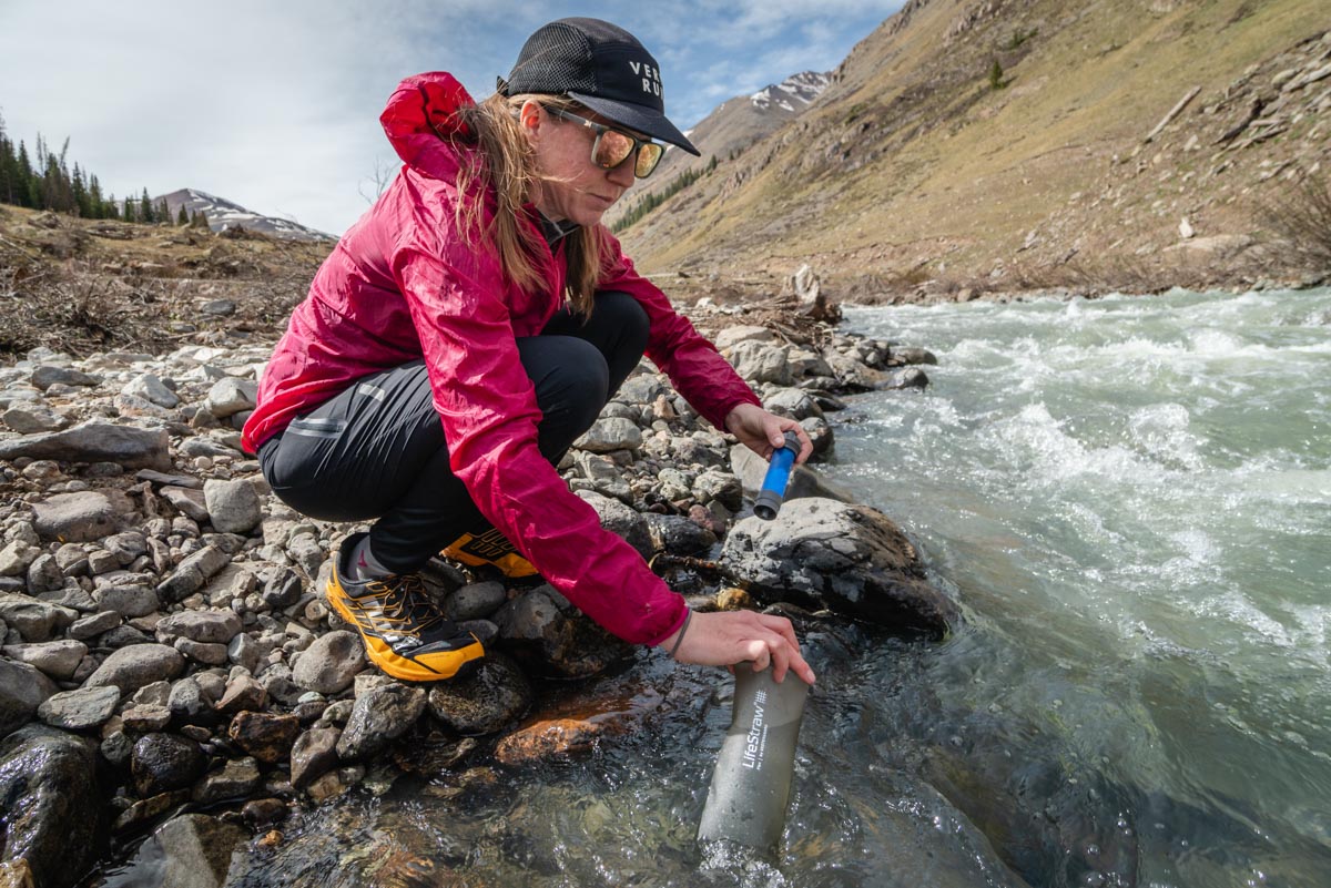 Best Running Rain Jacket - runner in jacket filtering water in mountain ...