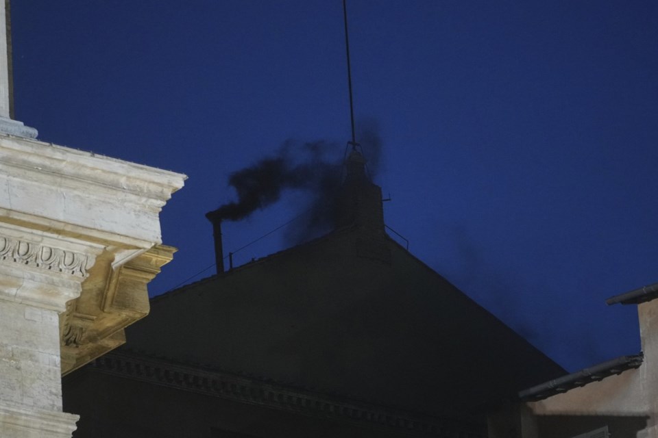 BLACK SMOKE BILLOWS FROM THE SISTINE CHAPEL CHIMNEY INDICATING NO POPE ELECTED ON DAY ONE OF THE ...